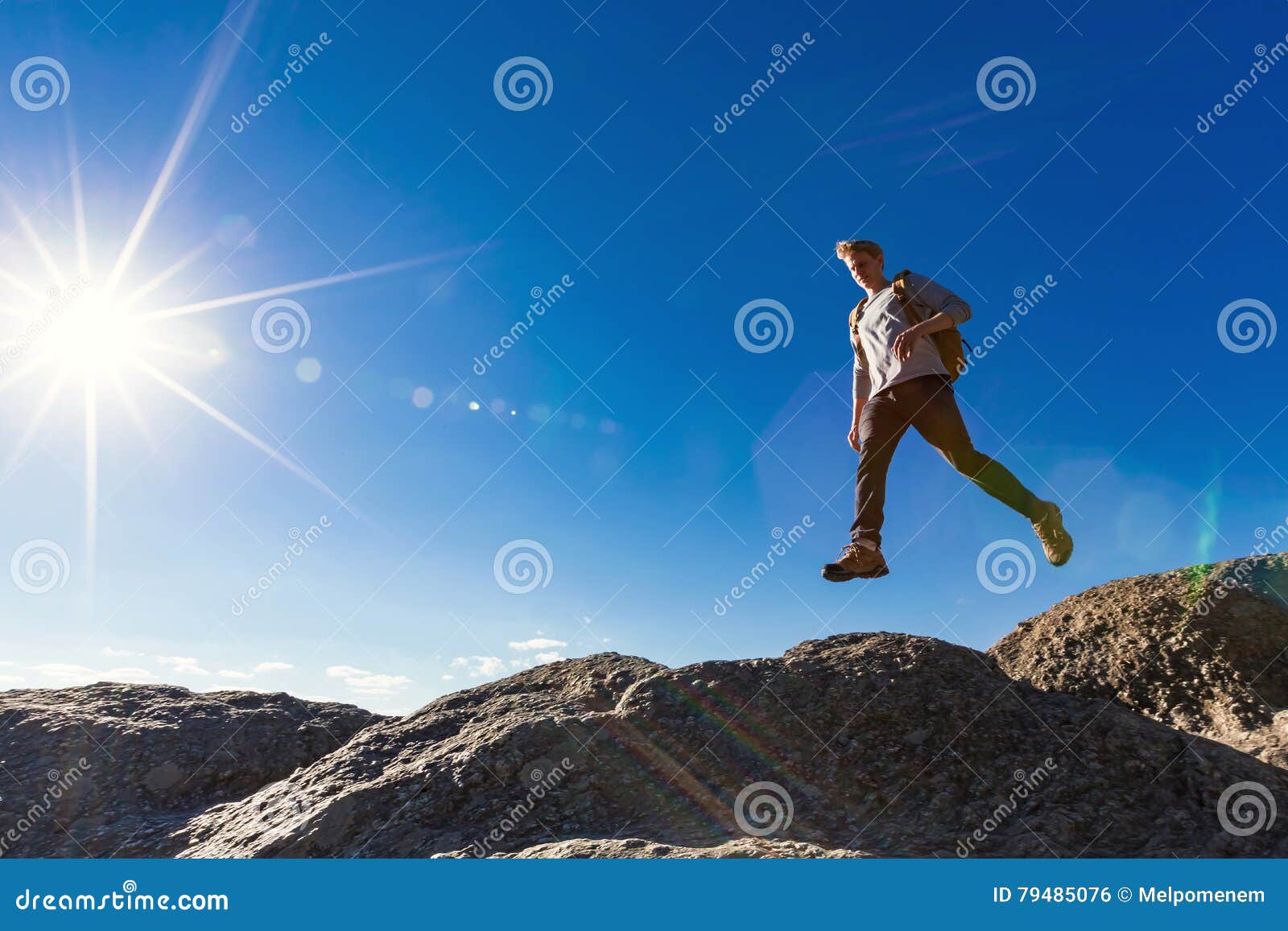 Man Jumping Over Gap on Mountain Hike Stock Photo - Image of nature ...