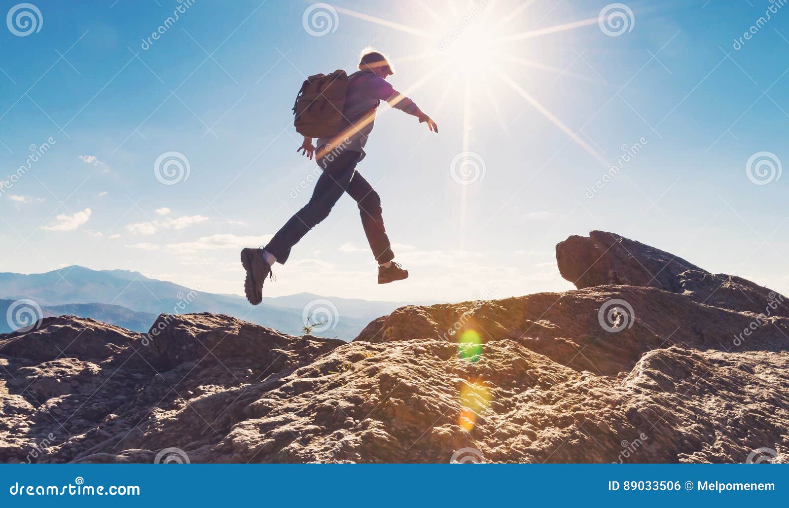Man Jumping Over Gap on Mountain Hike Stock Photo - Image of high, leap ...