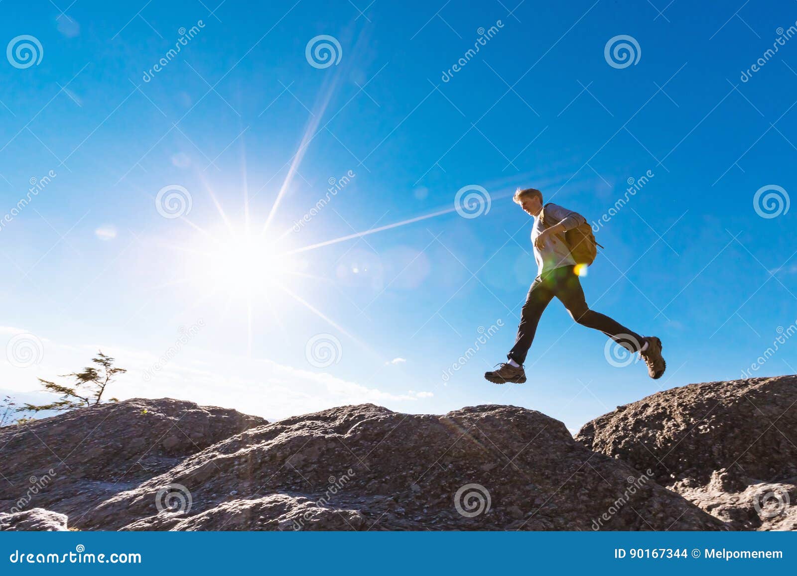 Man Jumping Over Gap on Mountain Hike Stock Photo - Image of freedom ...