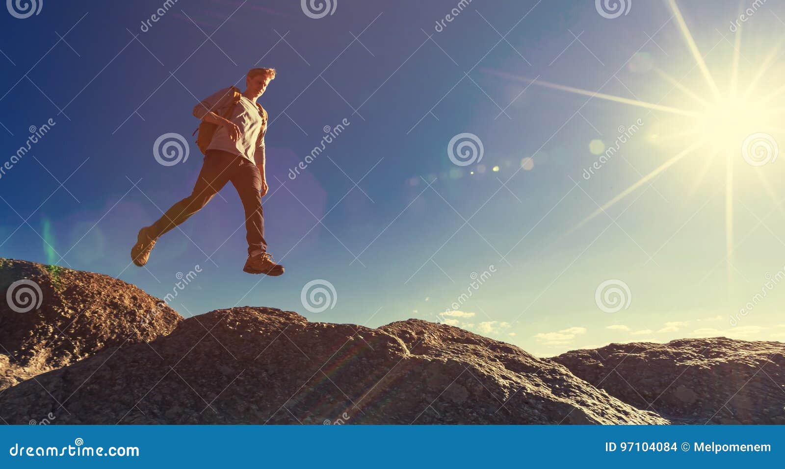 Man Jumping Over Gap on Mountain Hike Stock Photo - Image of autumn ...