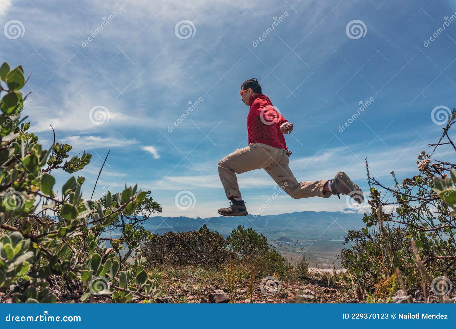 Man Jumping Over Rocks in Mountain Stock Image - Image of athlete ...