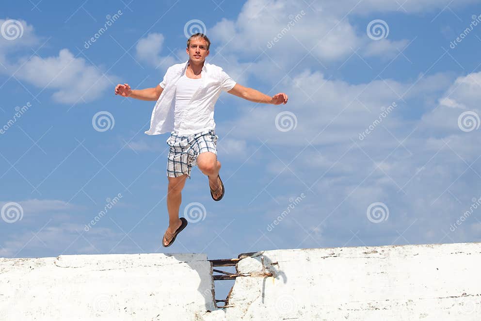 Man Jumping Over Wall stock image. Image of handsome - 20354579
