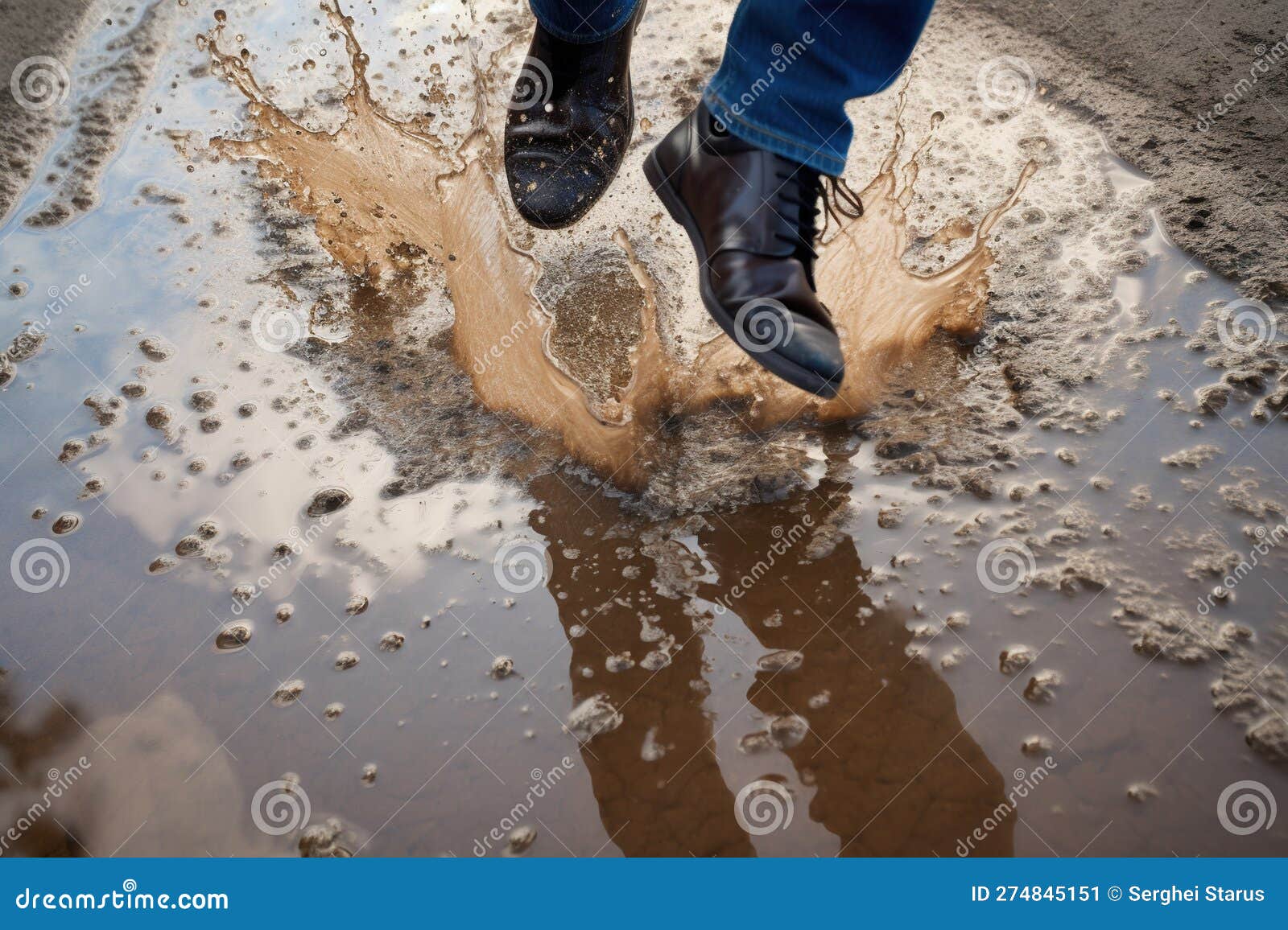 Man Jumping in a Puddle, Splashes of Dirty Water. High Angle View, only ...
