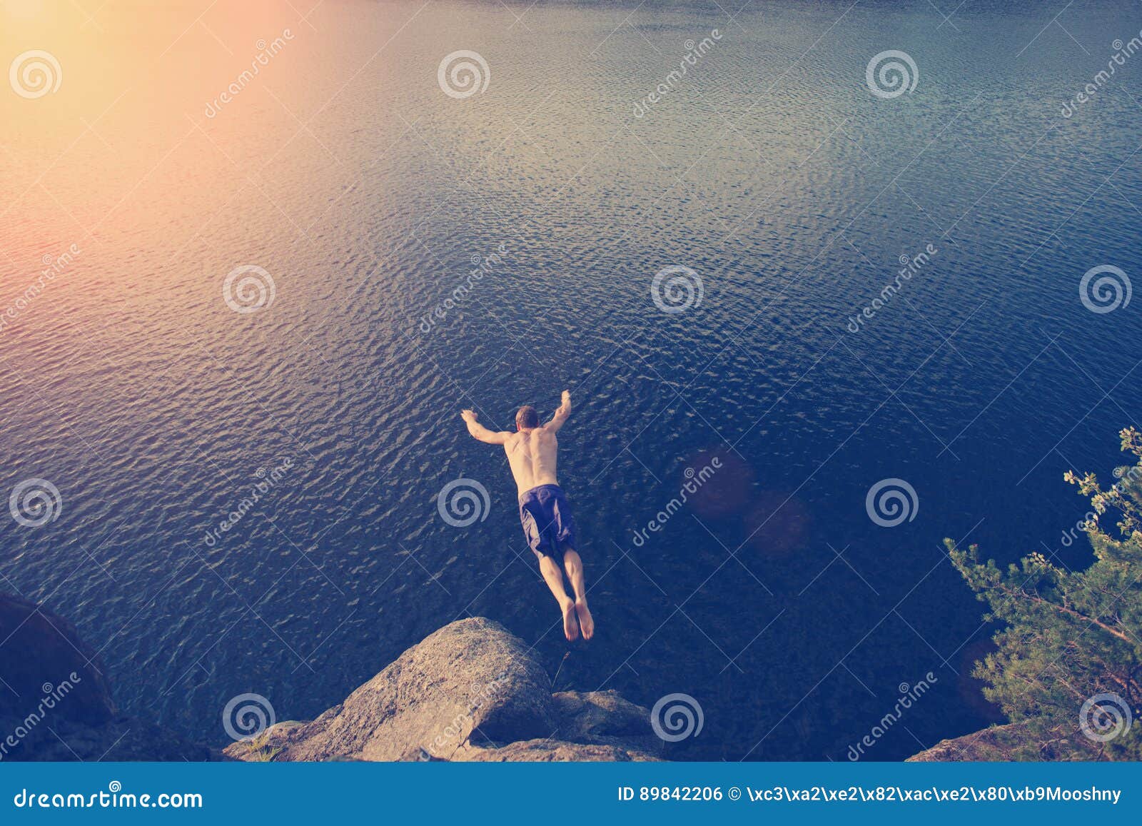 Man Jumping into the River from Cliff Stock Photo - Image of leader ...