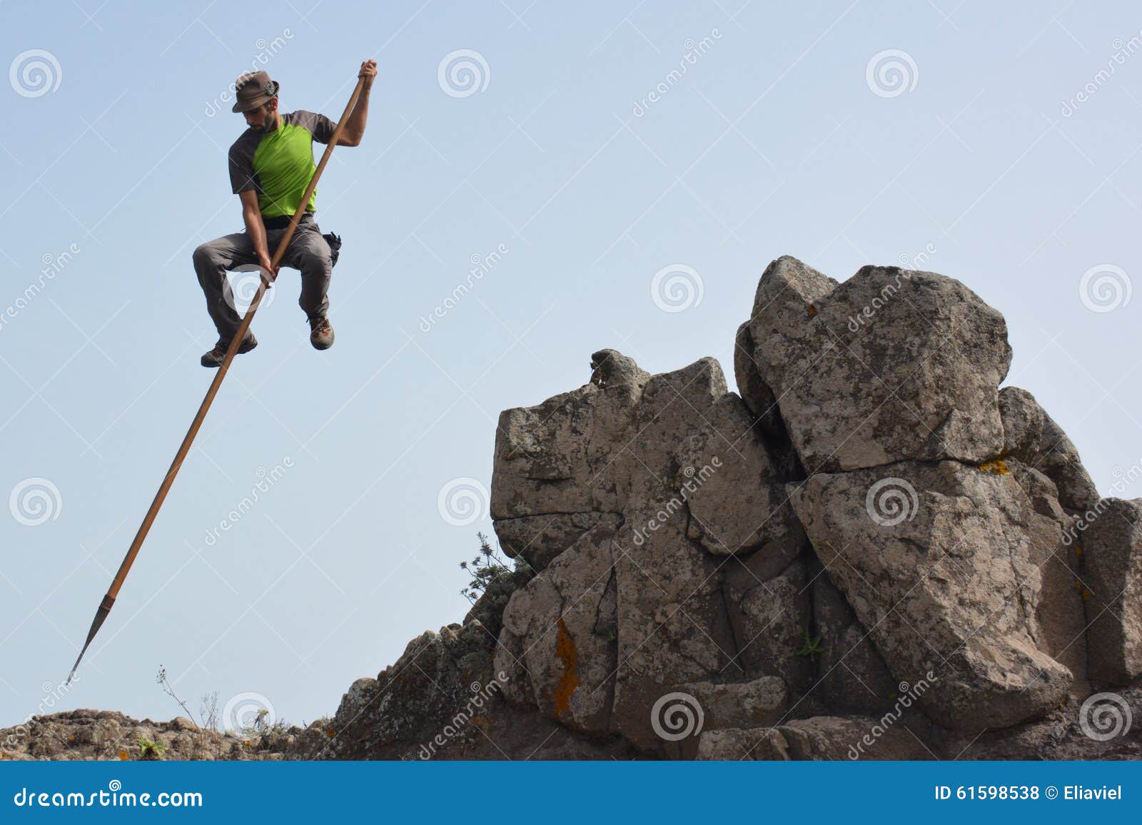A man jumping from a rock editorial stock photo. Image of lance - 61598538