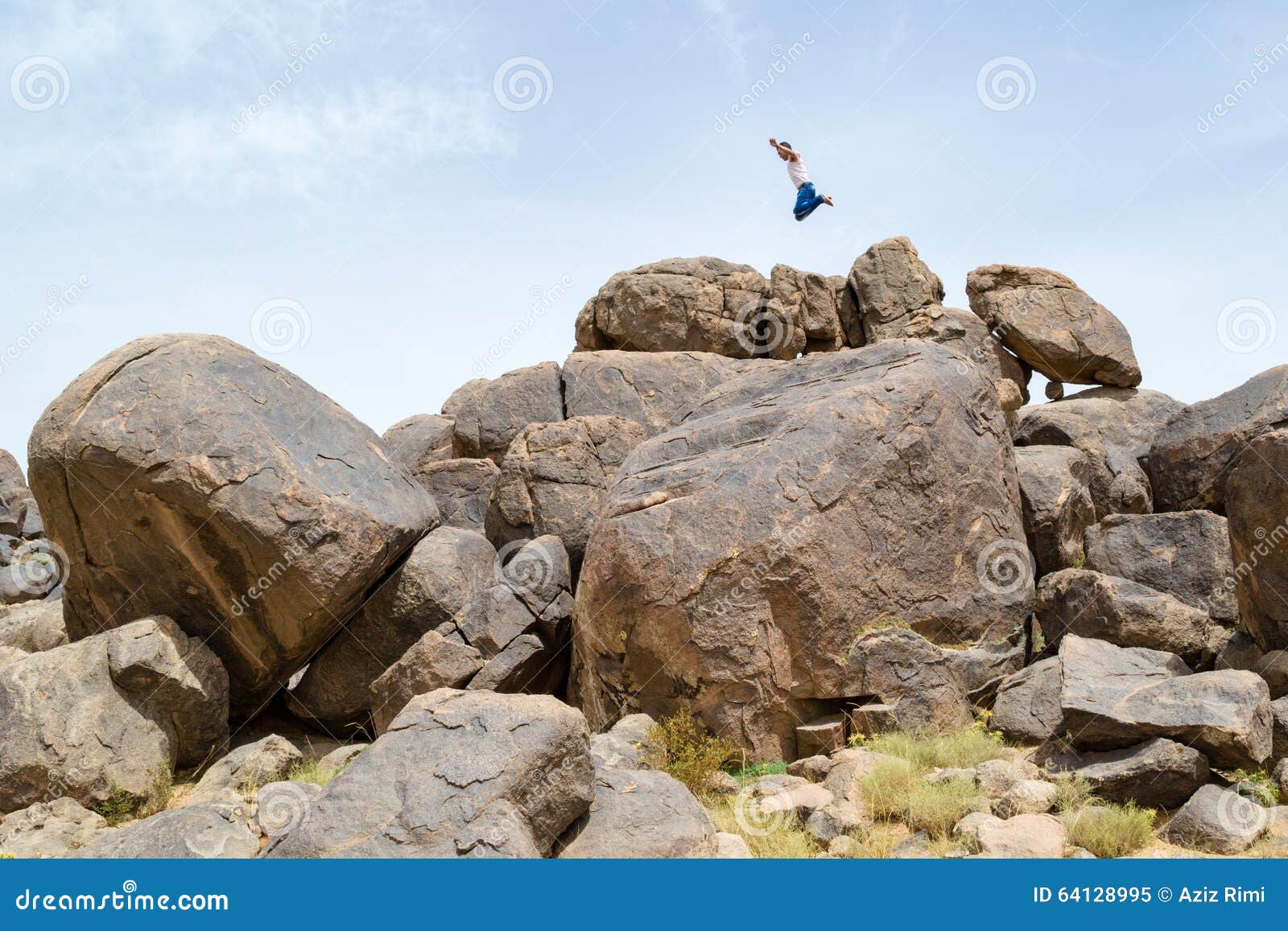 Man Jumping on Rocks in the Desert #1 Stock Image - Image of commercial ...