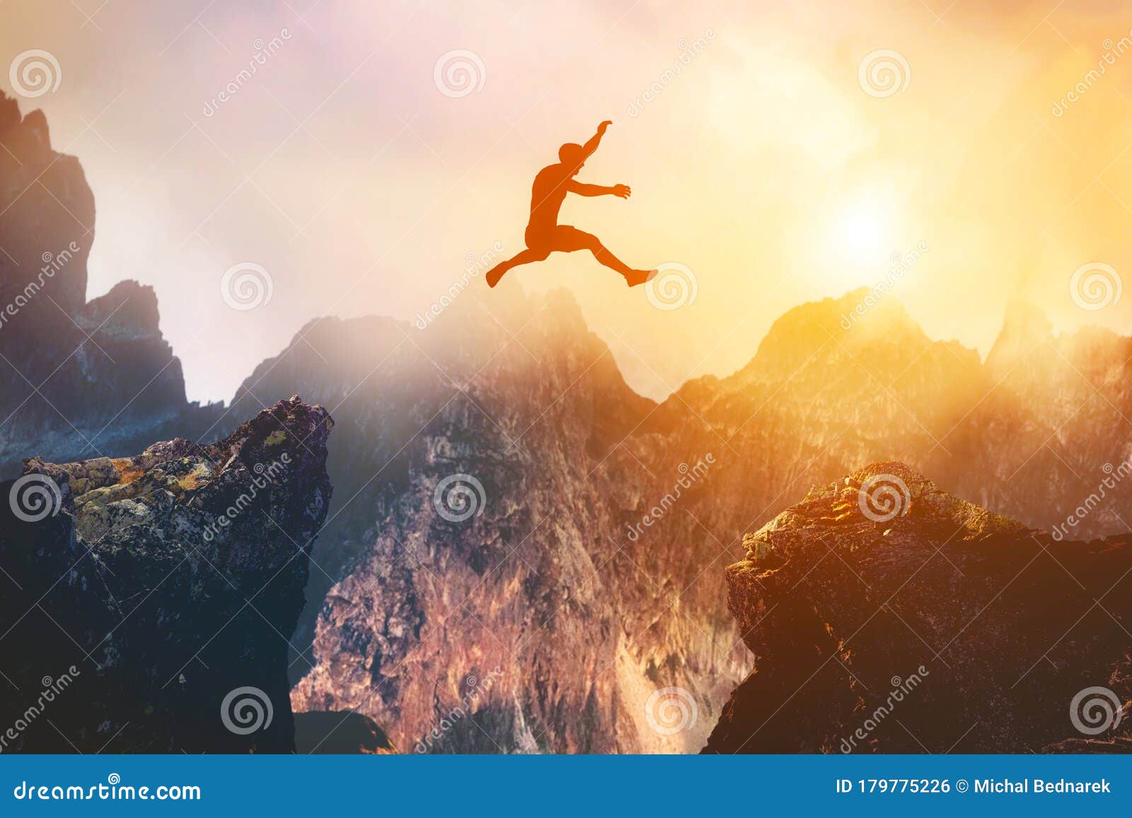 Jumping A Gap Between Two Rocks Stock Photo | CartoonDealer.com #159380910
