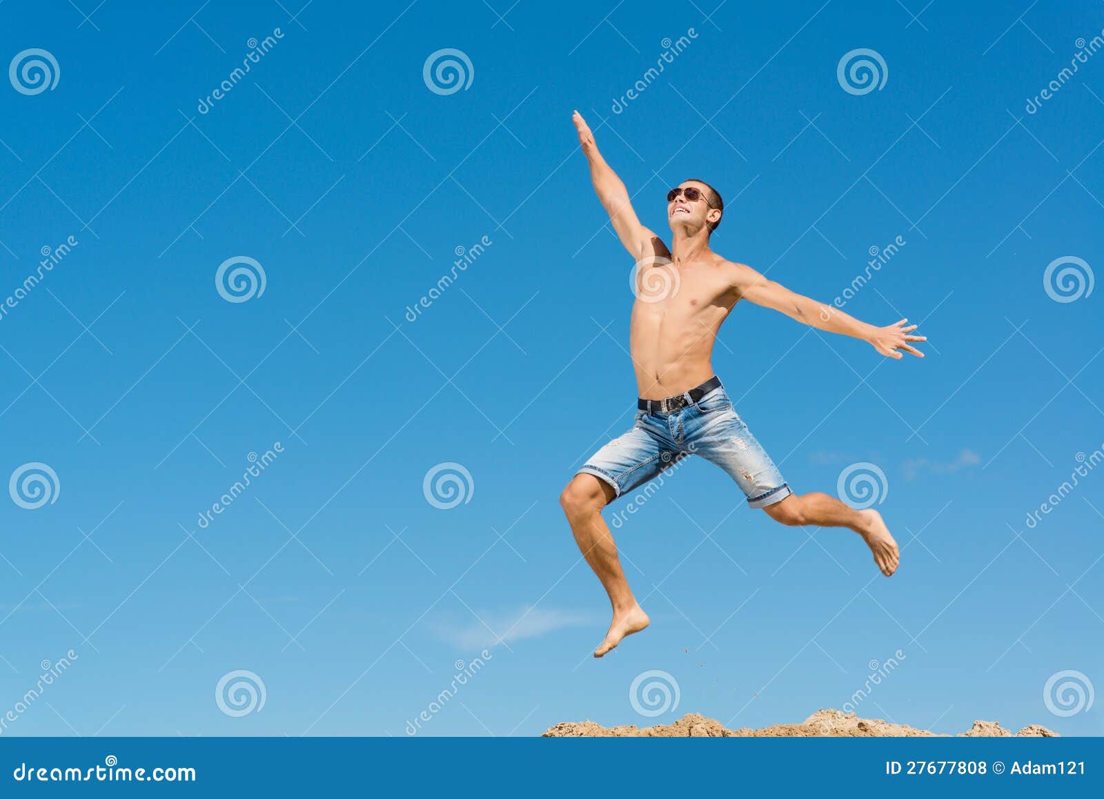 Man Jumping on the Sand, on a Background of Blue S Stock Photo - Image ...