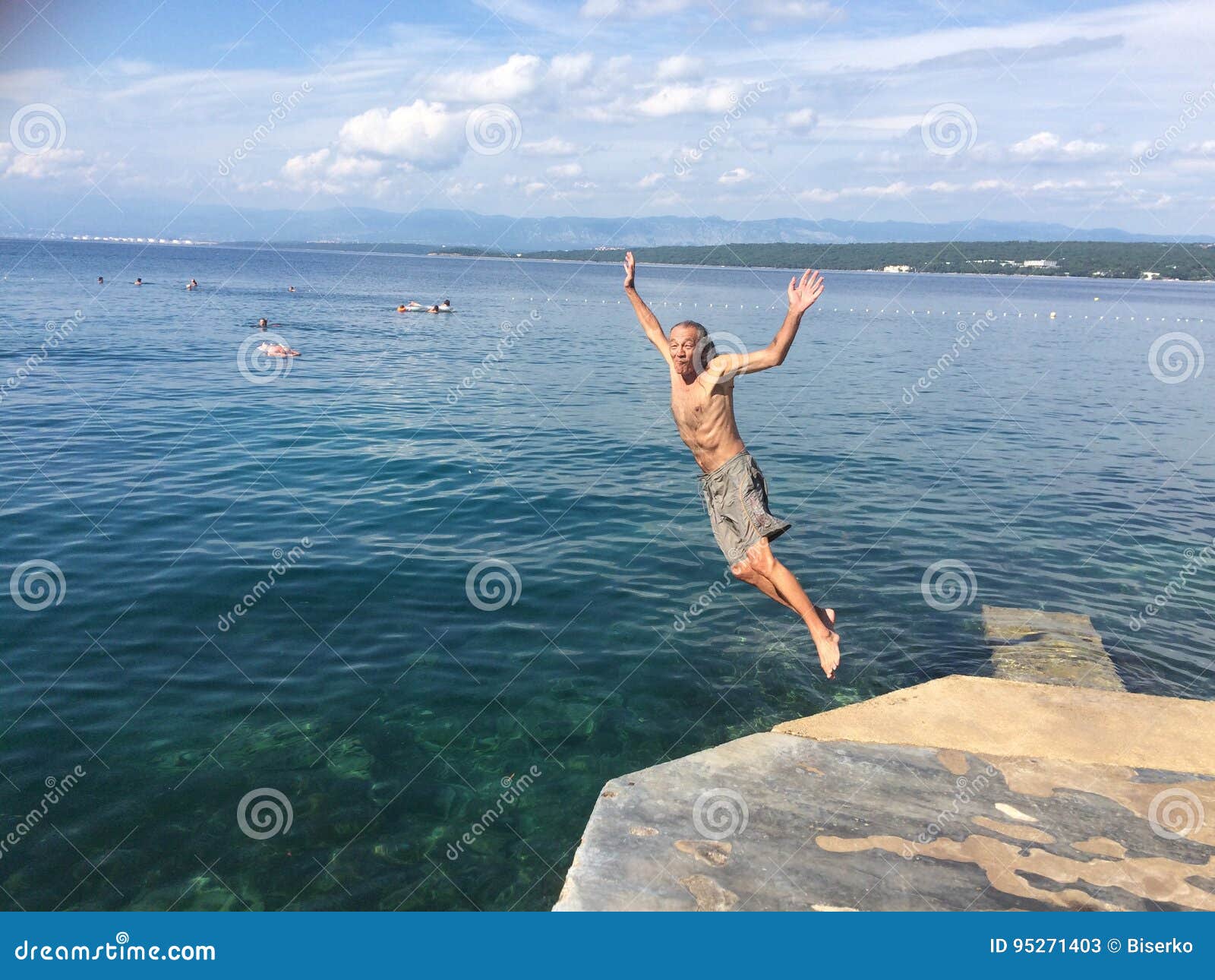 Man jumping in the sea stock image. Image of jumping - 95271403