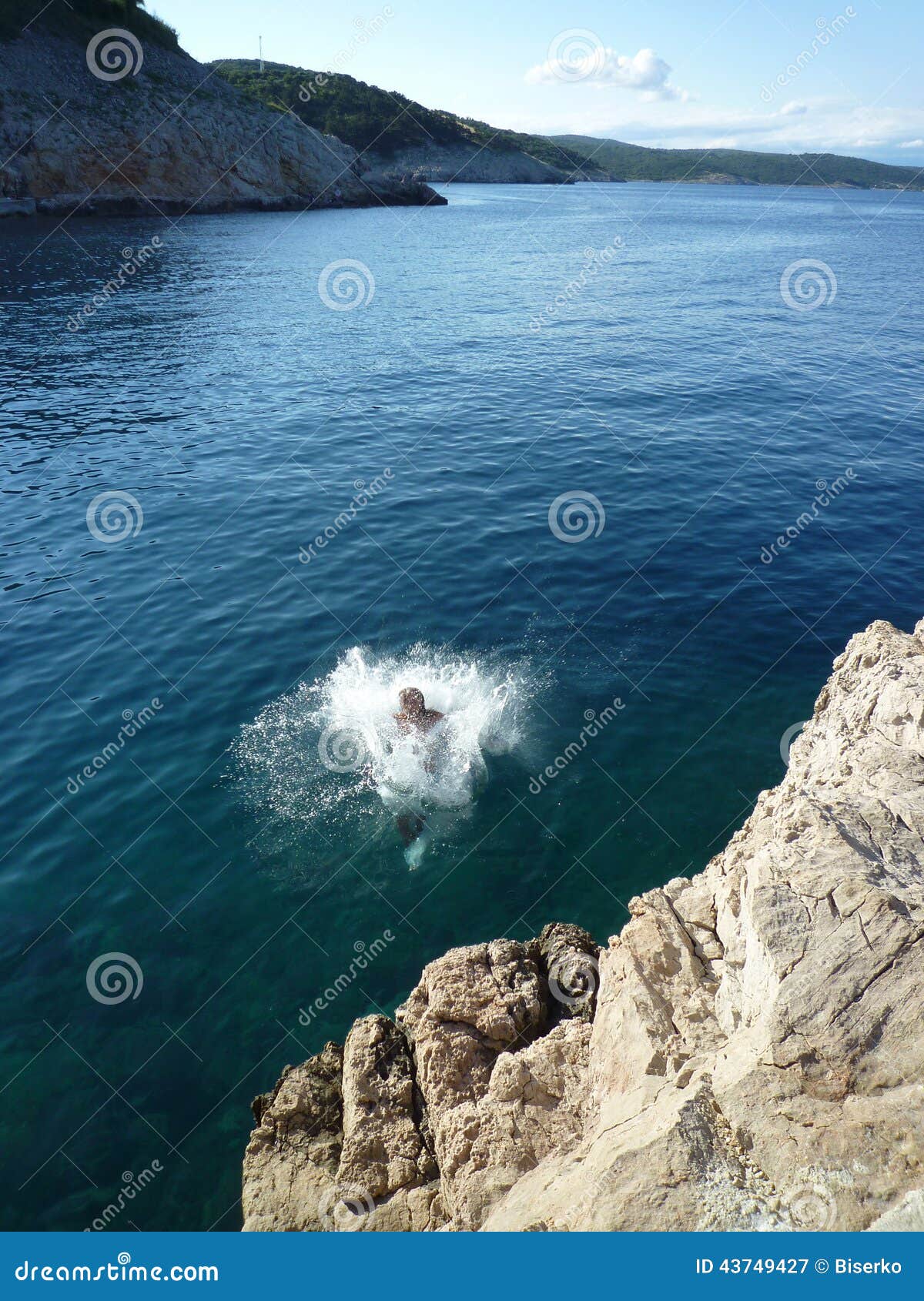 Man jumping in the sea stock image. Image of rocks, blue - 43749427