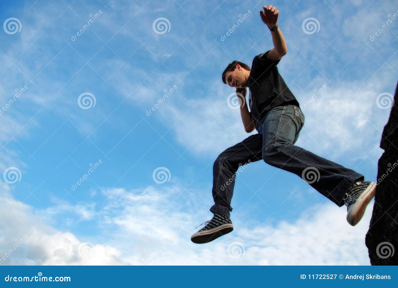 Man Jumping from Stone Edge Stock Image - Image of cloudscape, carefree ...