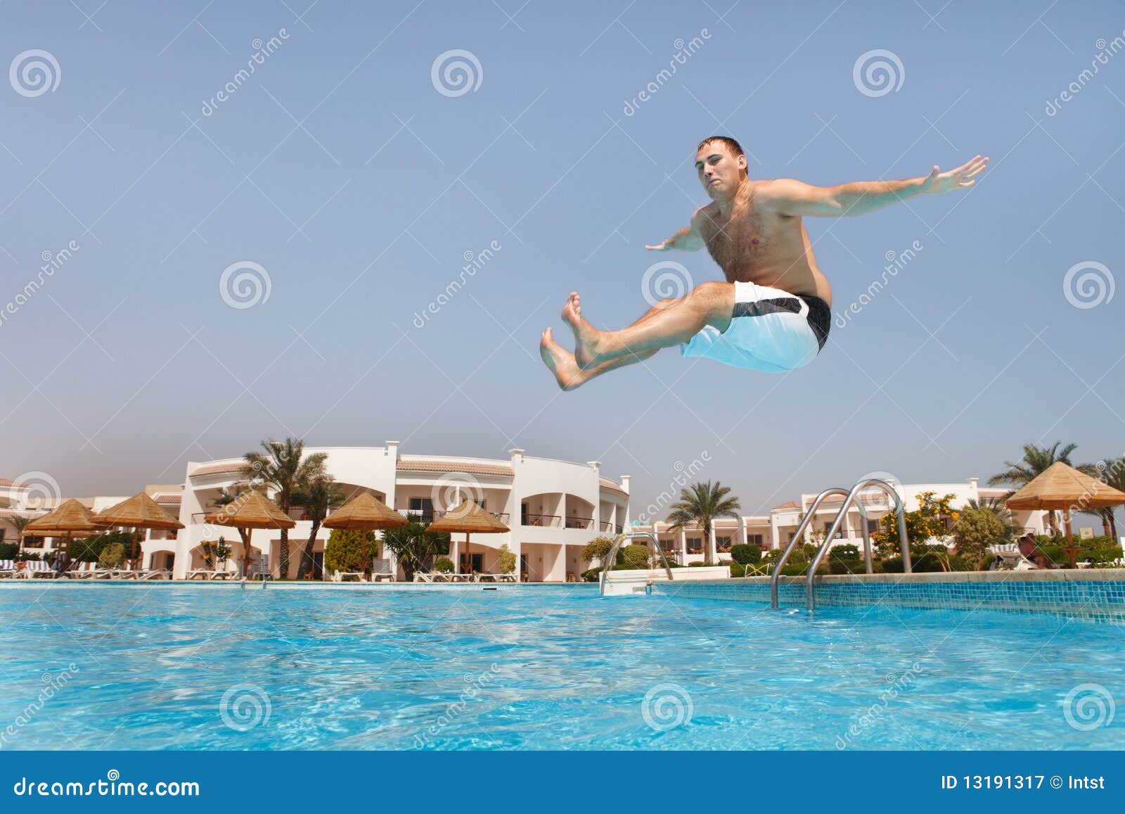 Man Jumping in Swimming Pool Stock Image - Image of resort, jumping ...