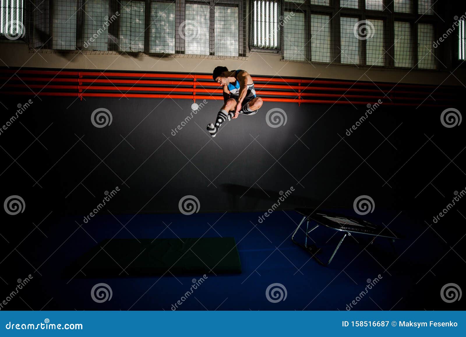 Man Jumping on the Trampoline in the Gym Stock Image - Image of orange ...