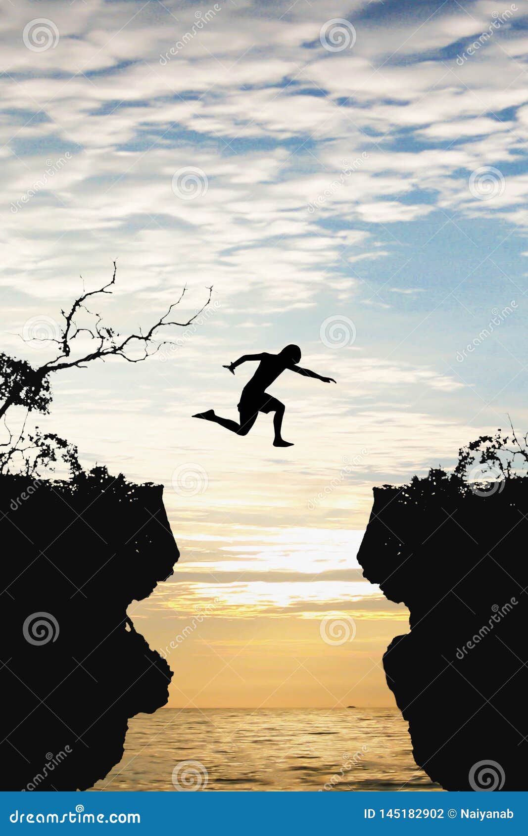 Man Jumping between Two Rocky Mountains at Sunset Stock Photo - Image ...