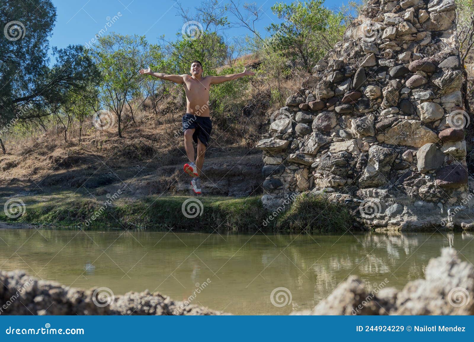 A Man Jumping into the Water in a River Stock Image - Image of ...