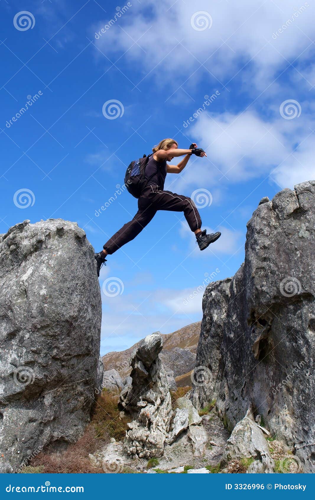 Man jumps from rock stock photo. Image of cape, glove - 3326996