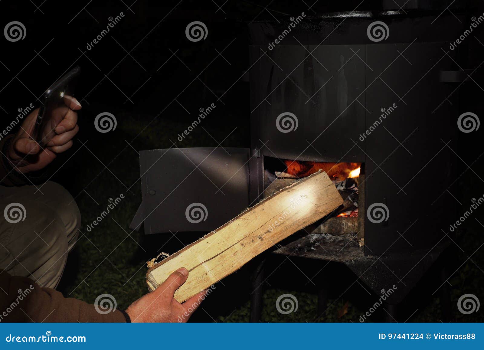 Man Keeping Fire at Night stock photo. Image of fireplace - 97441224