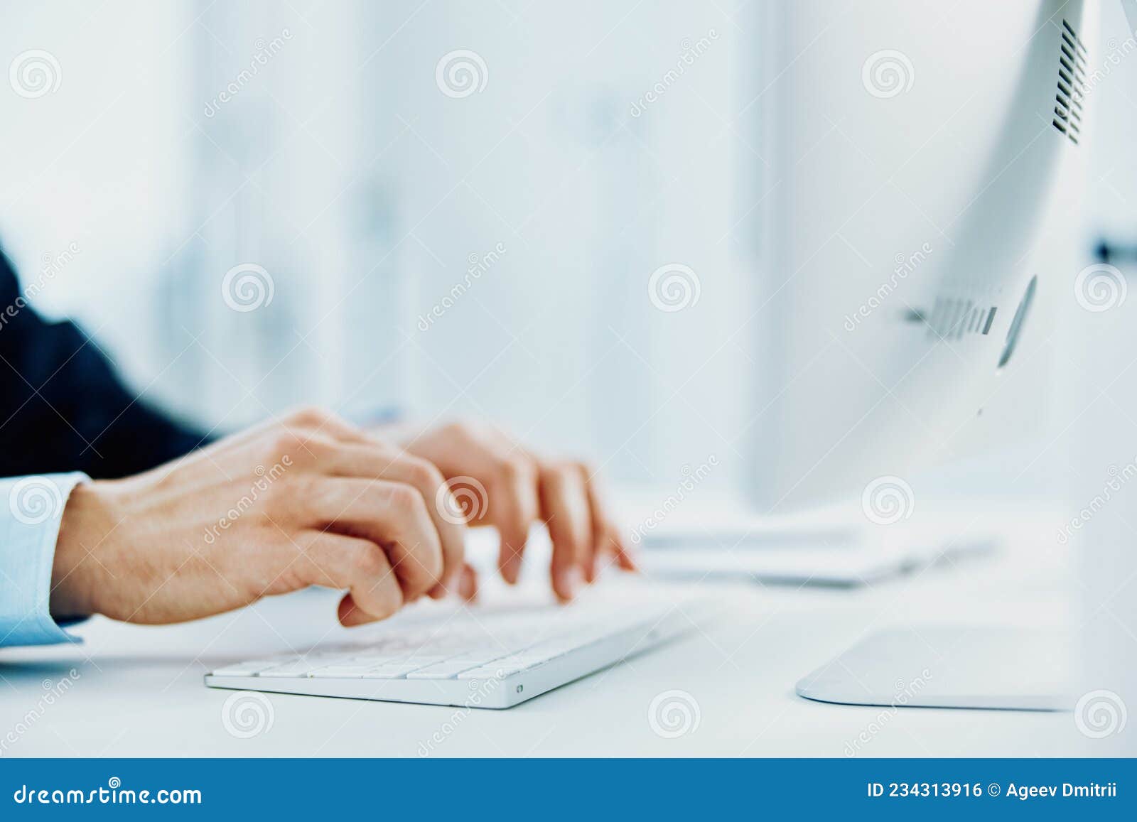 A Man with a Keyboard on a Desktop Office Working at a Computer Stock ...