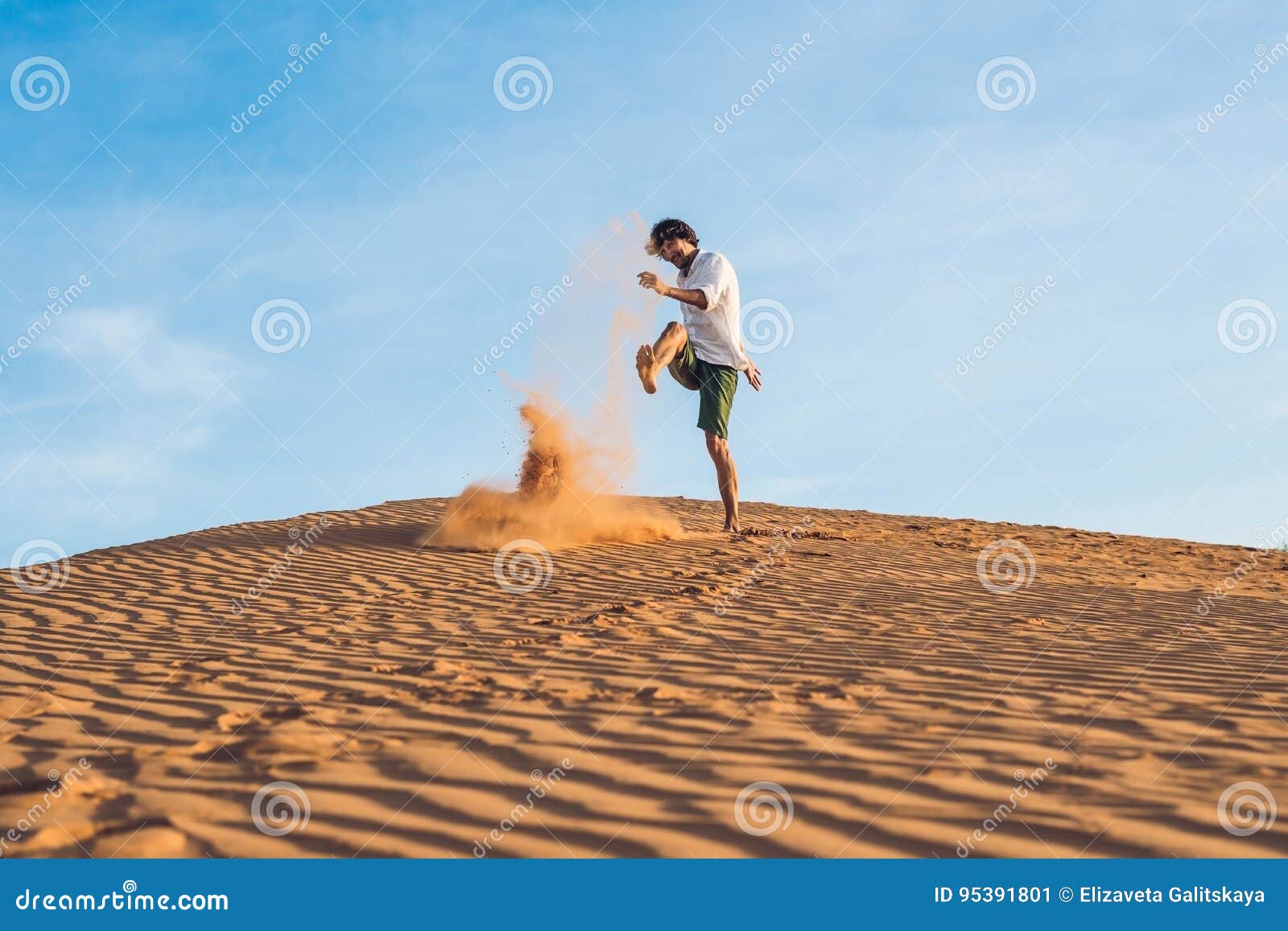 A Man is Kicking Sand in a Red Desert. Splash of Anger Concept Stock ...