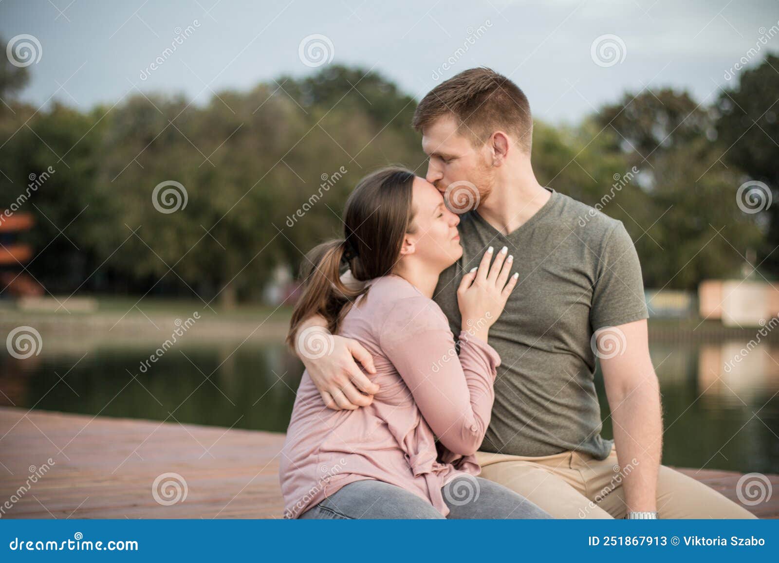 Man Kisses His Partner On Her Forehead On The Beach Stock Image Image