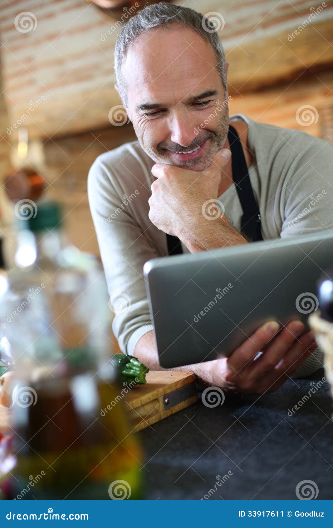 Man in Kitchen Checking Recipe on Internet Stock Image - Image of ...