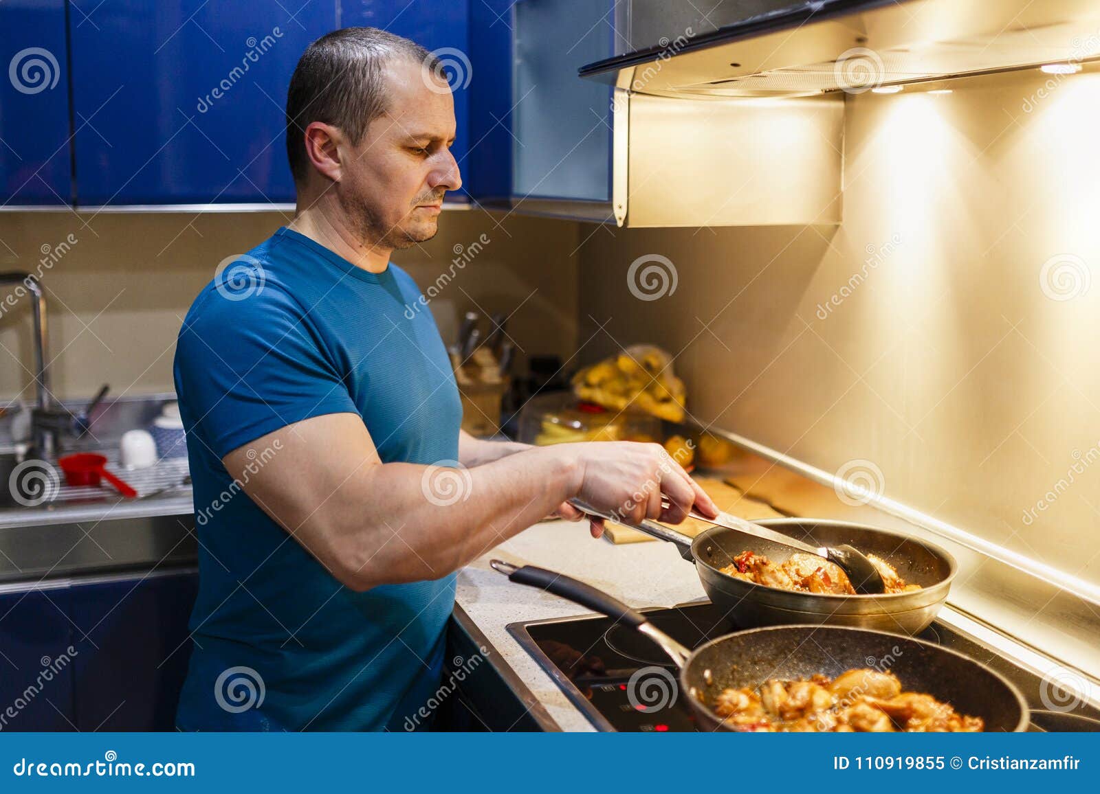 Man in the Kitchen is Cooking at Home at the Wok Stock Image - Image of ...