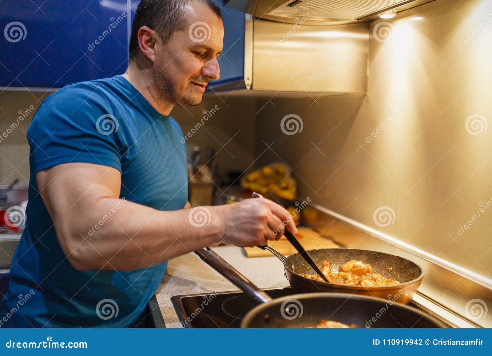 Man in the Kitchen is Cooking at Home at the Wok Stock Photo - Image of ...