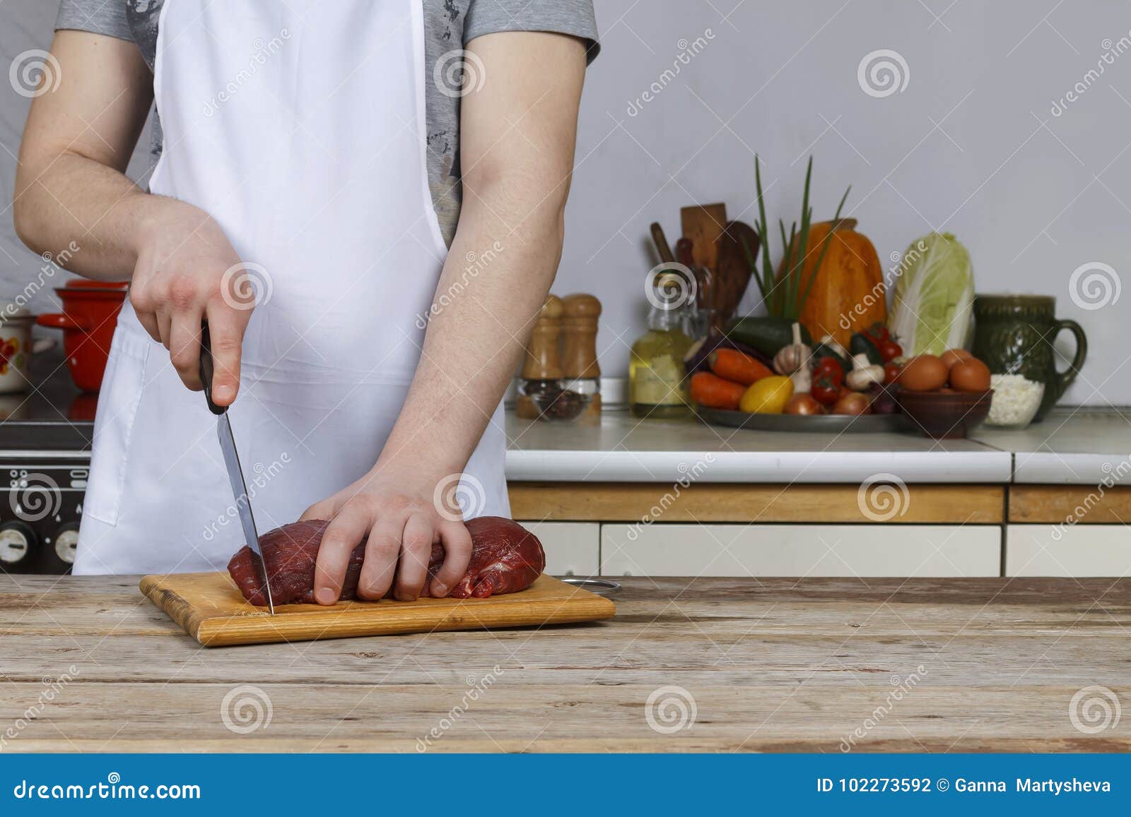 Man in the Kitchen Cutting a Piece of Meat Stock Photo - Image of meat ...