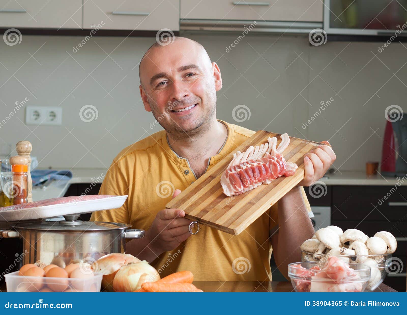 Man in kitchen with meat stock image. Image of kitchen - 38904365