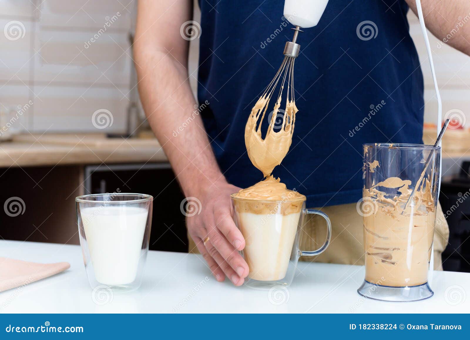 A Man in the Kitchen is Preparing Dalgona Coffee, Whipped with a Mixer ...