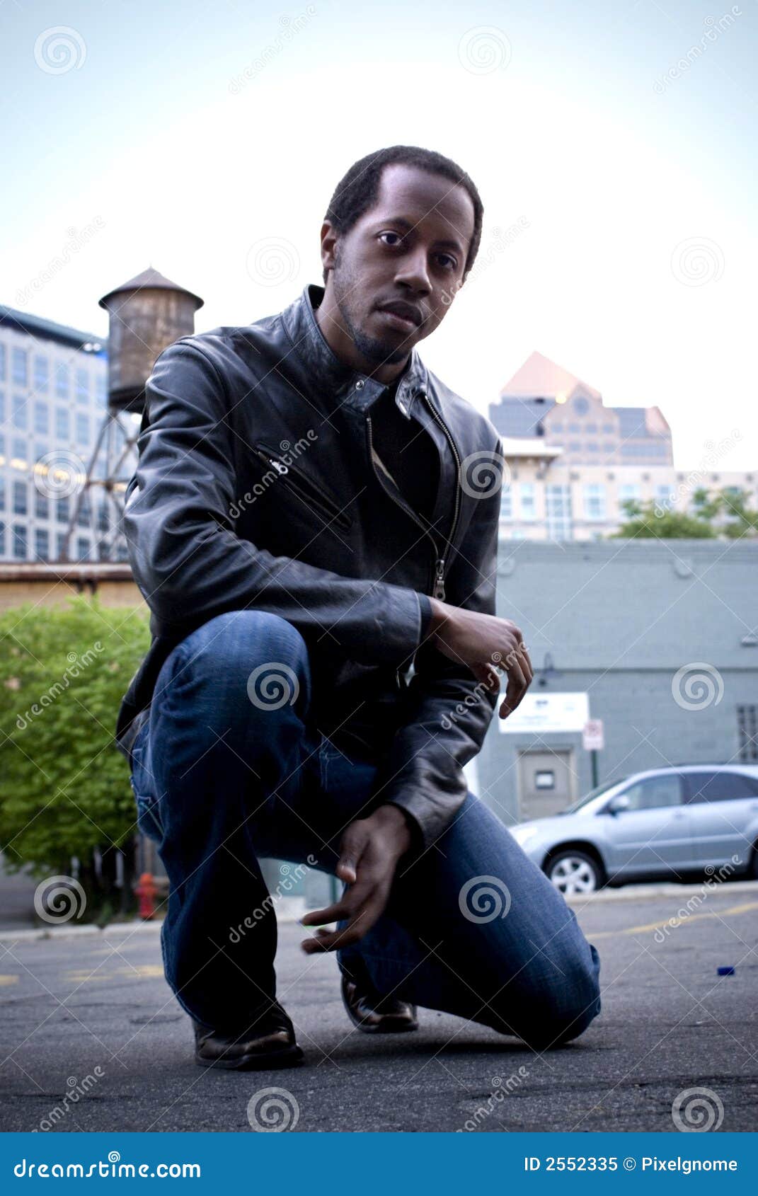 Man kneeling on street stock image. Image of concrete - 2552335