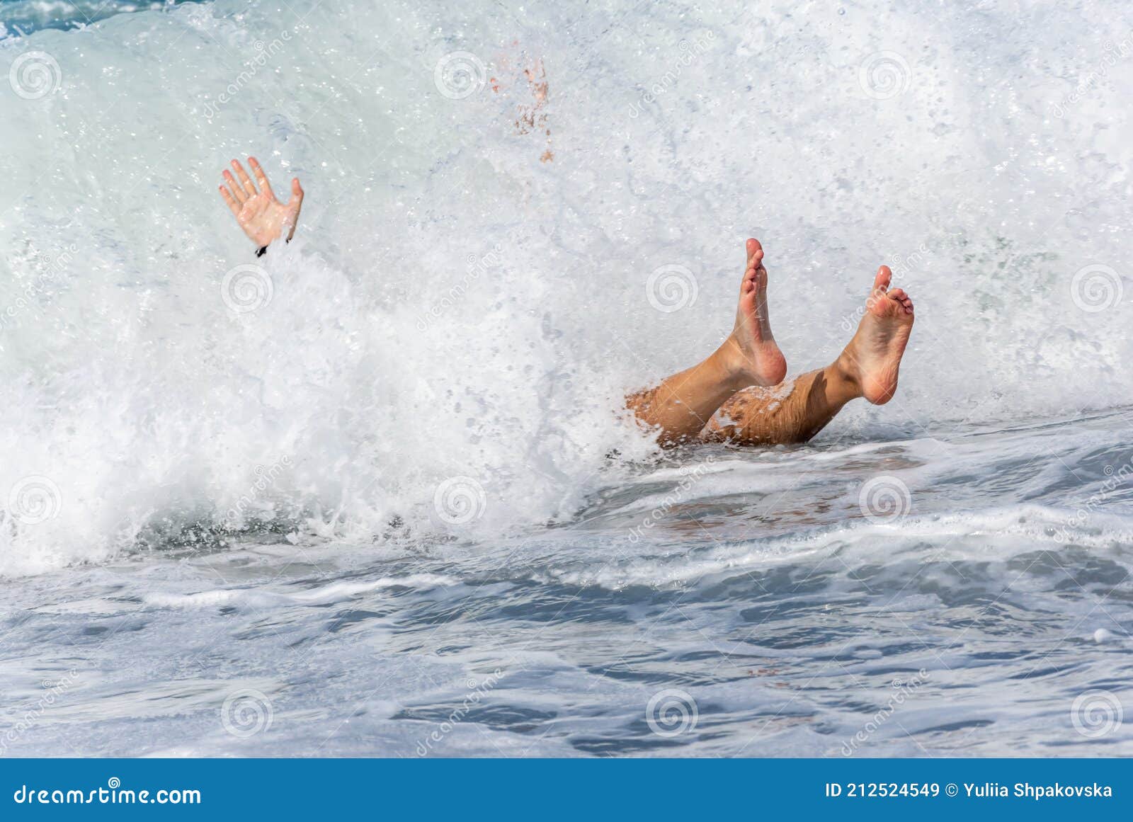 Man knocked down by a wave stock image. Image of feet - 212524549