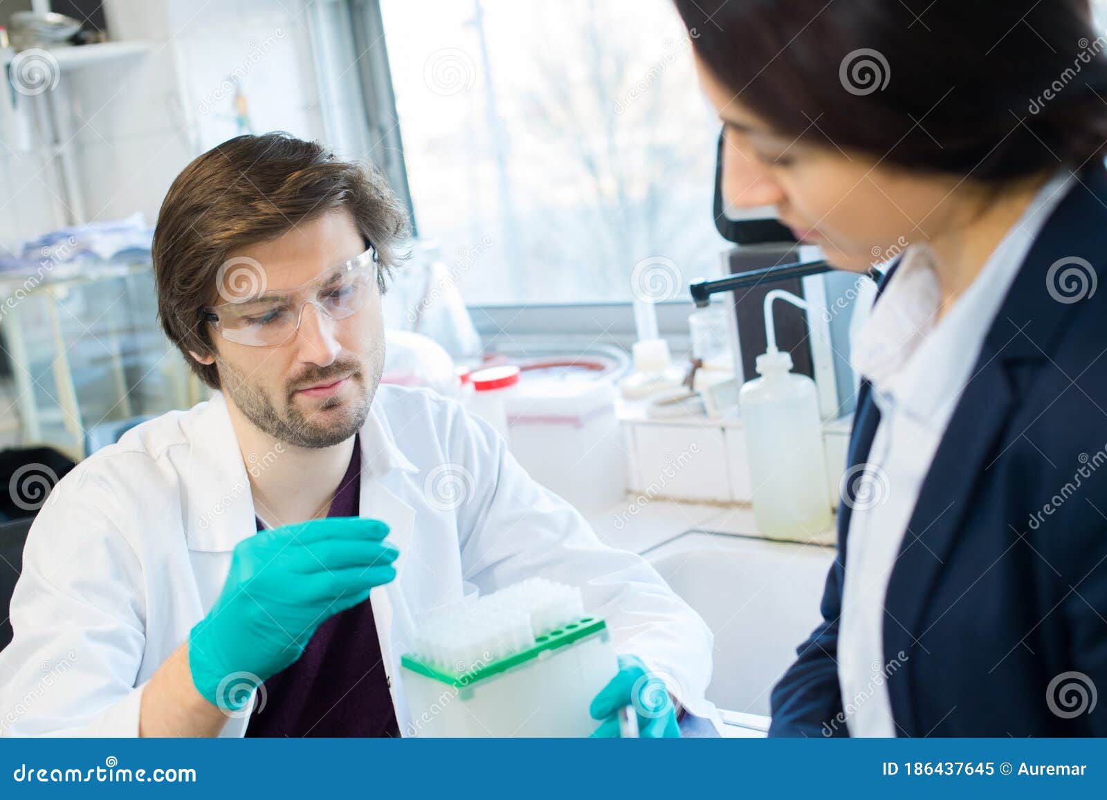 Man in Lab Coats and Woman Manager Talking Stock Image - Image of ...