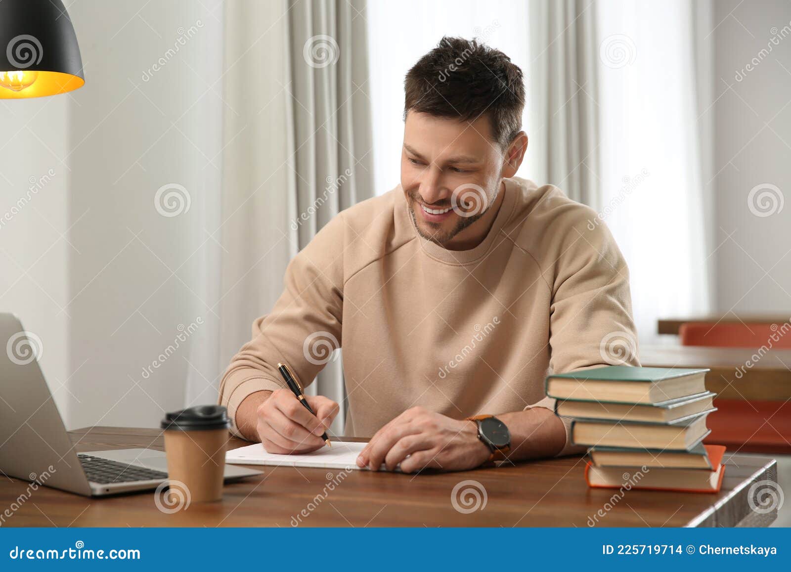 Man with Laptop and Books Studying at Table Stock Photo - Image of ...