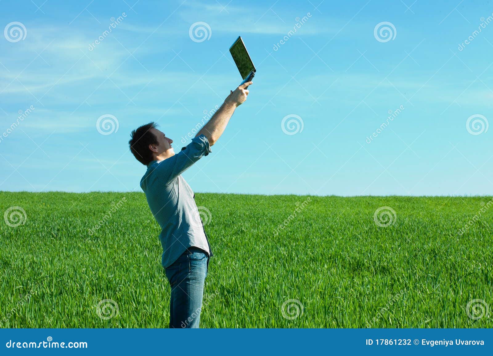 Man with Laptop Standing in a Field Stock Photo - Image of horizon ...