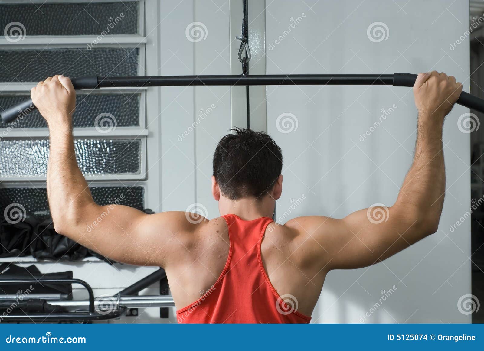 Fit Man On Lat Pull Down Machine At The Health Club. Work Out On Pull ...