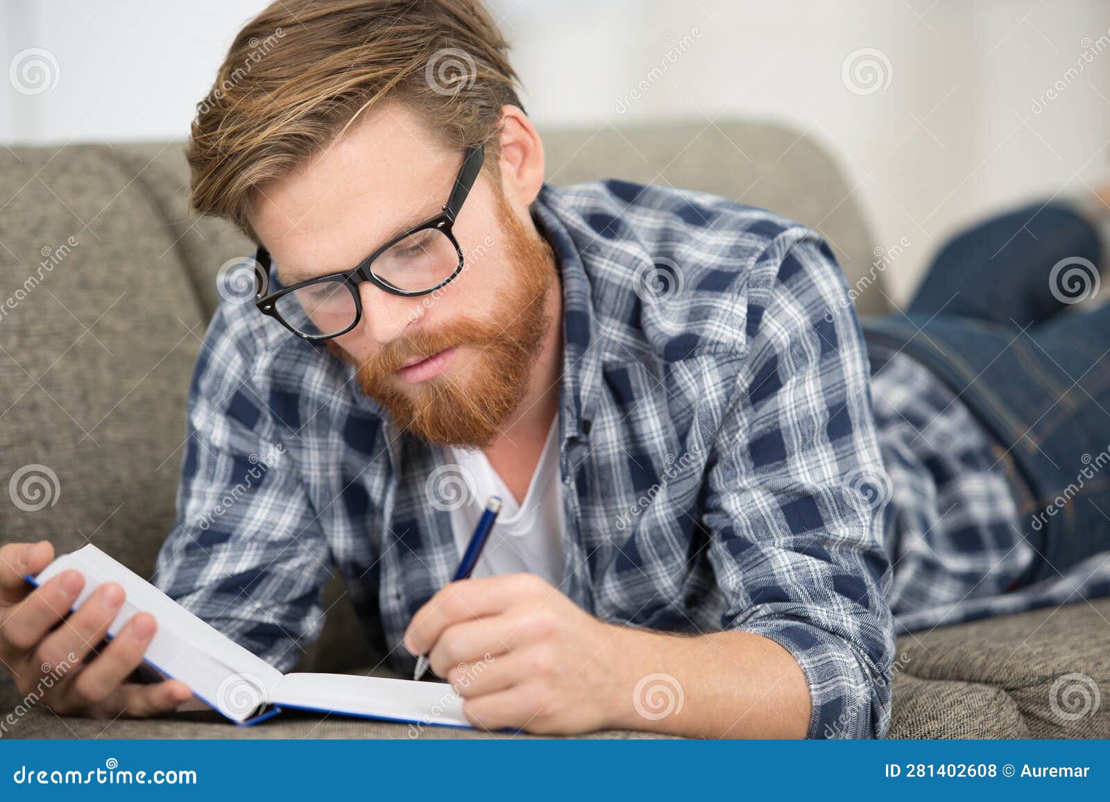 Man Layed on Sofa Writing in Notebook Stock Photo - Image of notebook ...