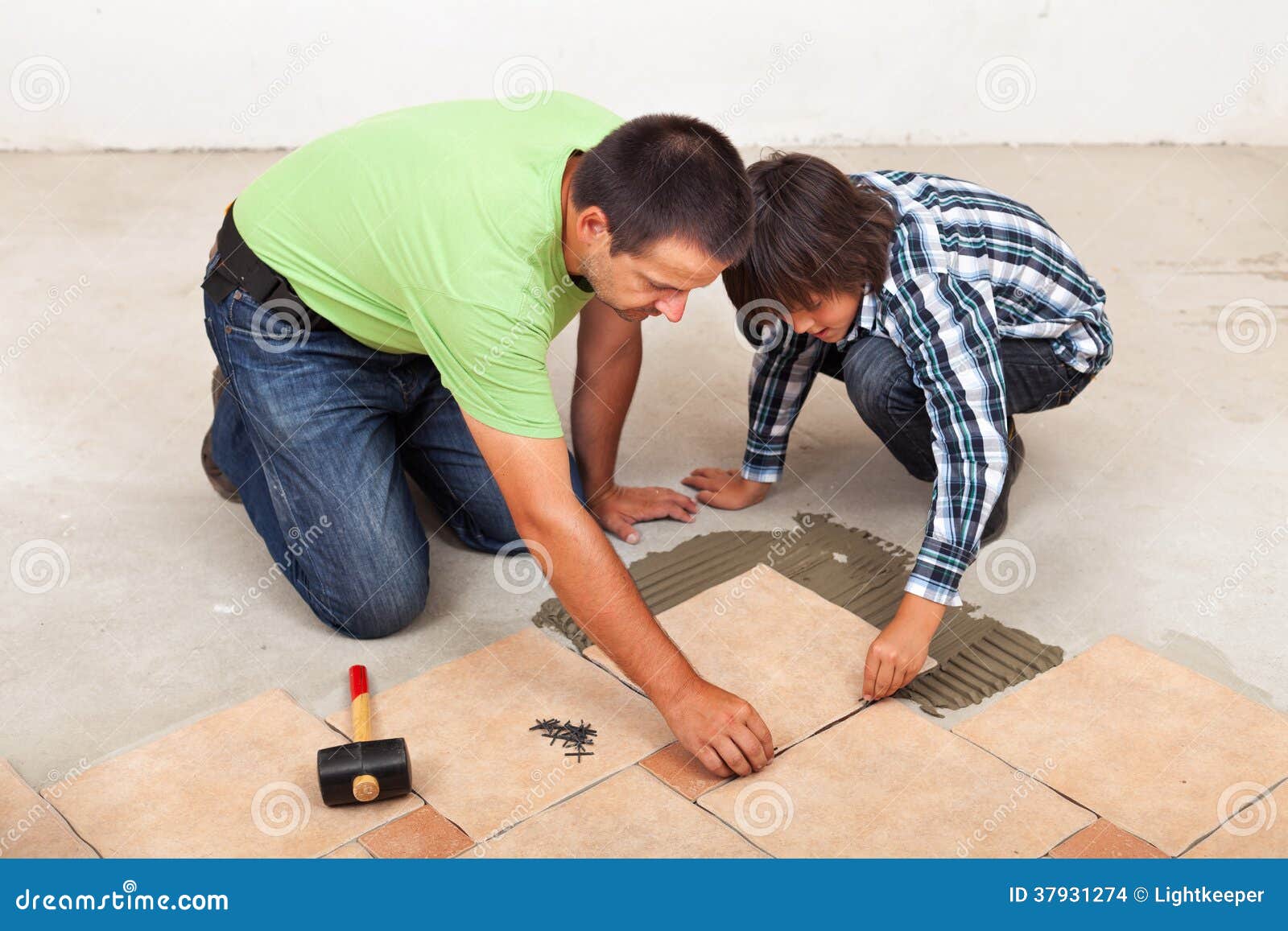 Man Laying Ceramic Floor Tiles Helped by His Son Stock Photo - Image of ...
