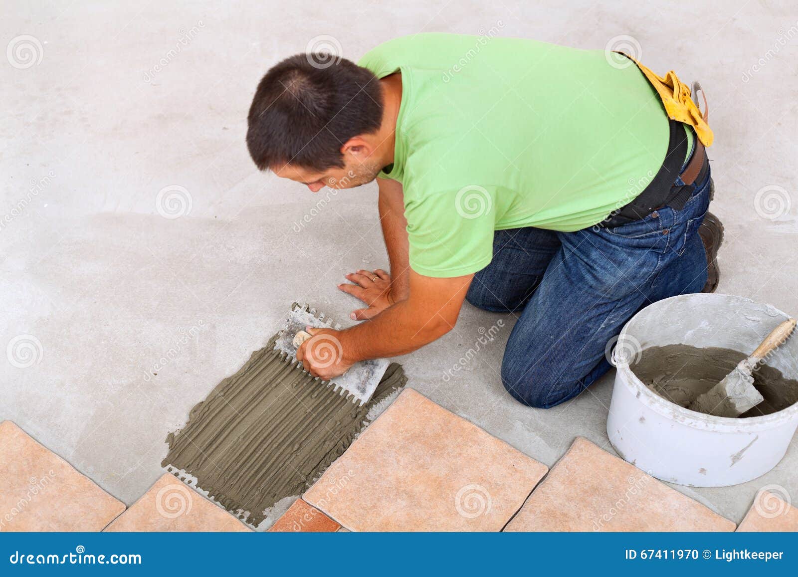Man Laying Ceramic Tiles Floor - Spreading the Adhesive Stock Photo ...