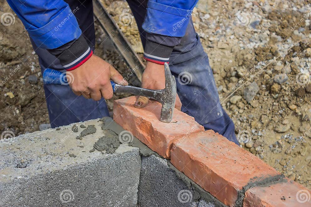 Man Laying Concrete Block and Bricks Wall Stock Image - Image of ...