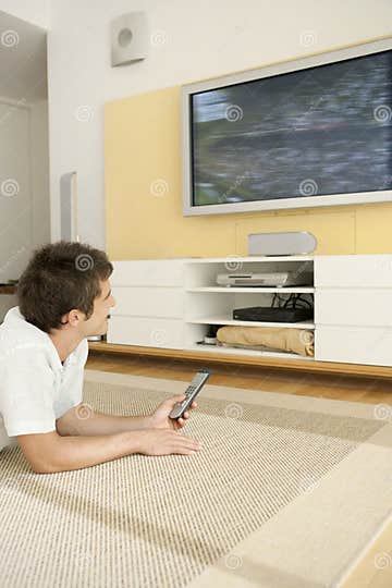 Man Laying Down on Floor Watching TV Stock Photo - Image of break ...