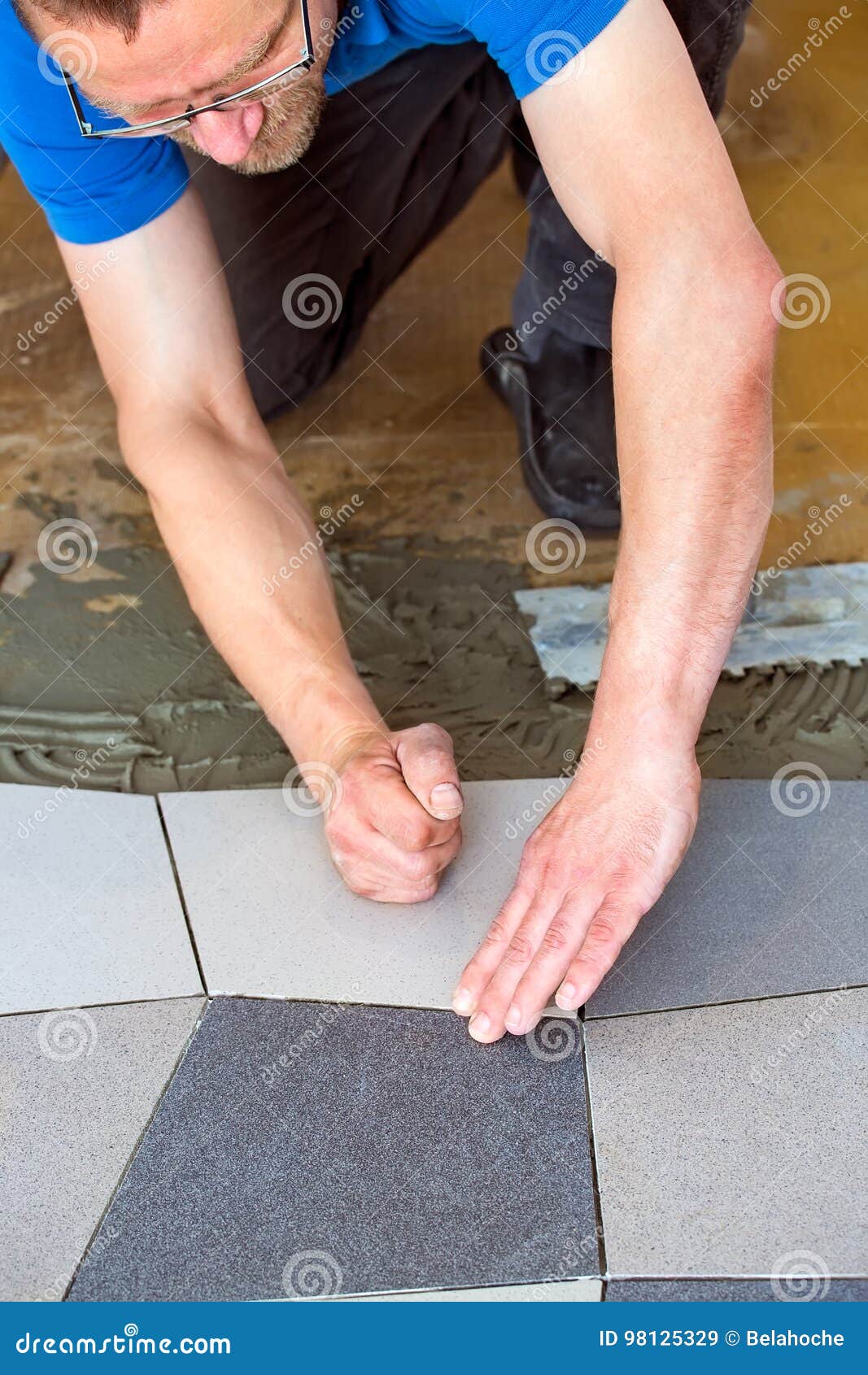 Man Laying Floor Tiles on Adhesive Stock Image - Image of industry ...