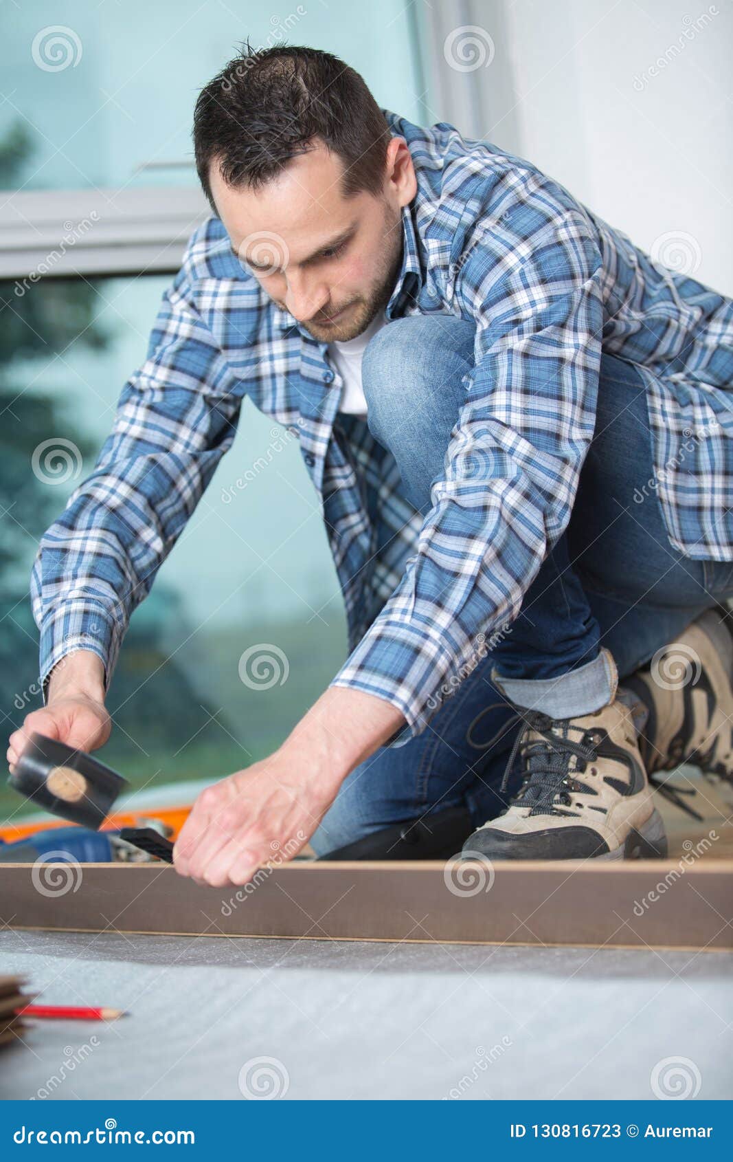Man Laying Laminate Flooring in Construction Concept Stock Image ...