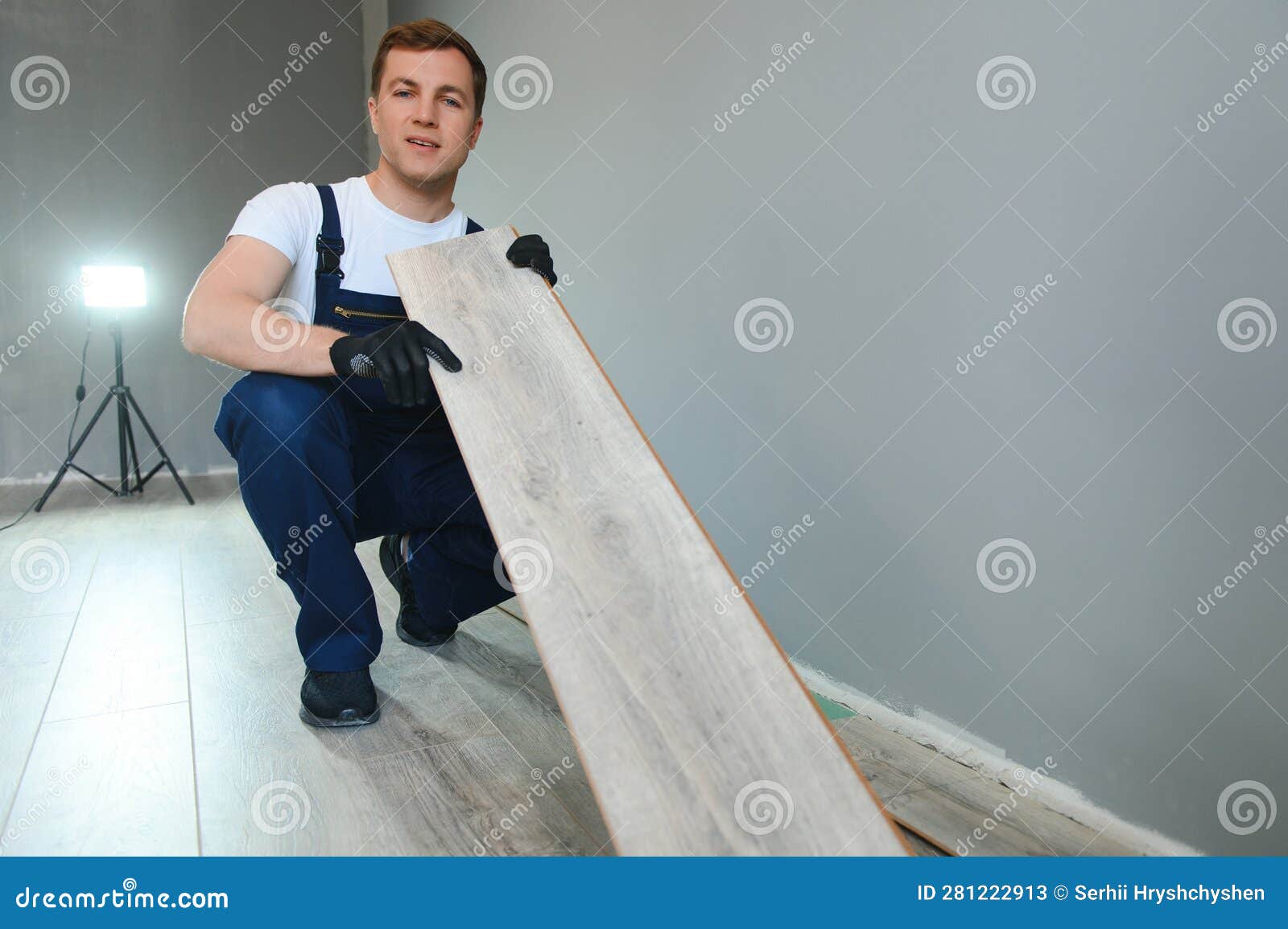 Man Laying Laminate Flooring in Construction Concept Stock Image ...