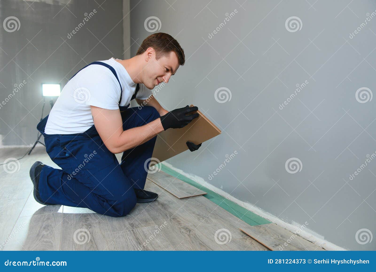 Man Laying Laminate Flooring in Construction Concept Stock Image ...