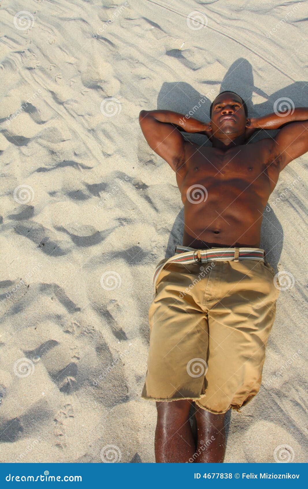 Man Laying on the Sand stock photo. Image of leisurely - 4677838