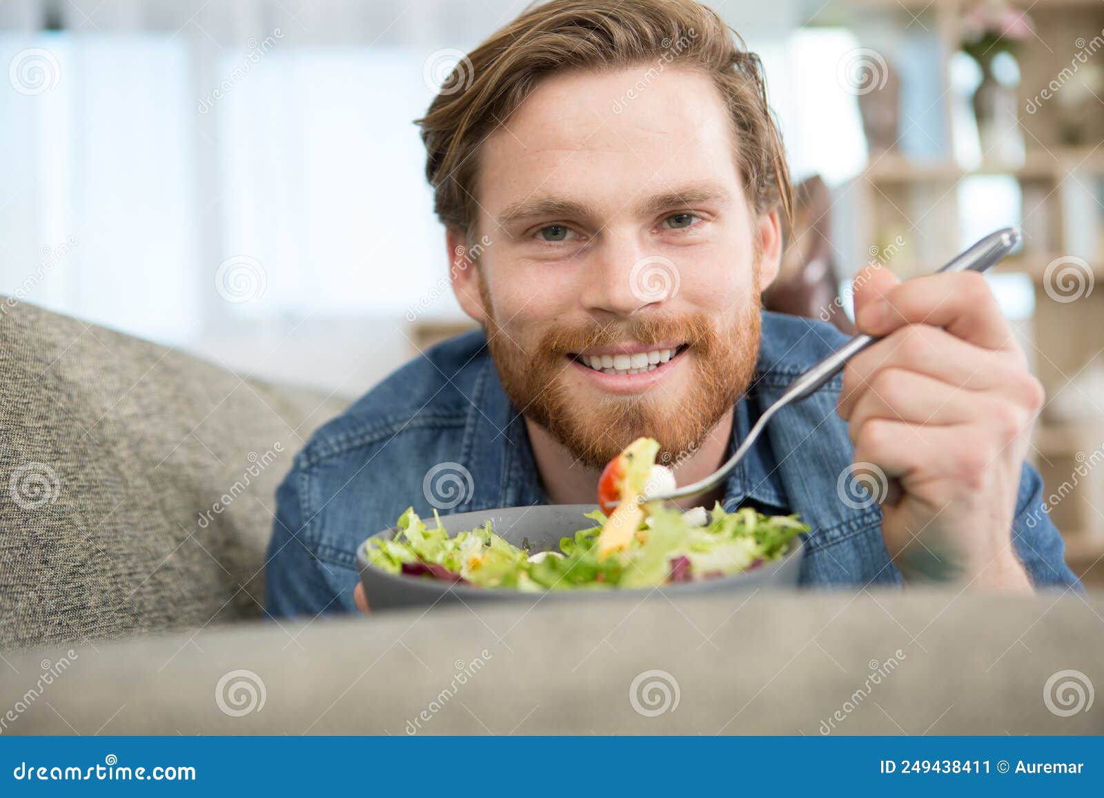 Man Laying on Sofa Eating Salad Stock Image - Image of tomatoes, diet ...