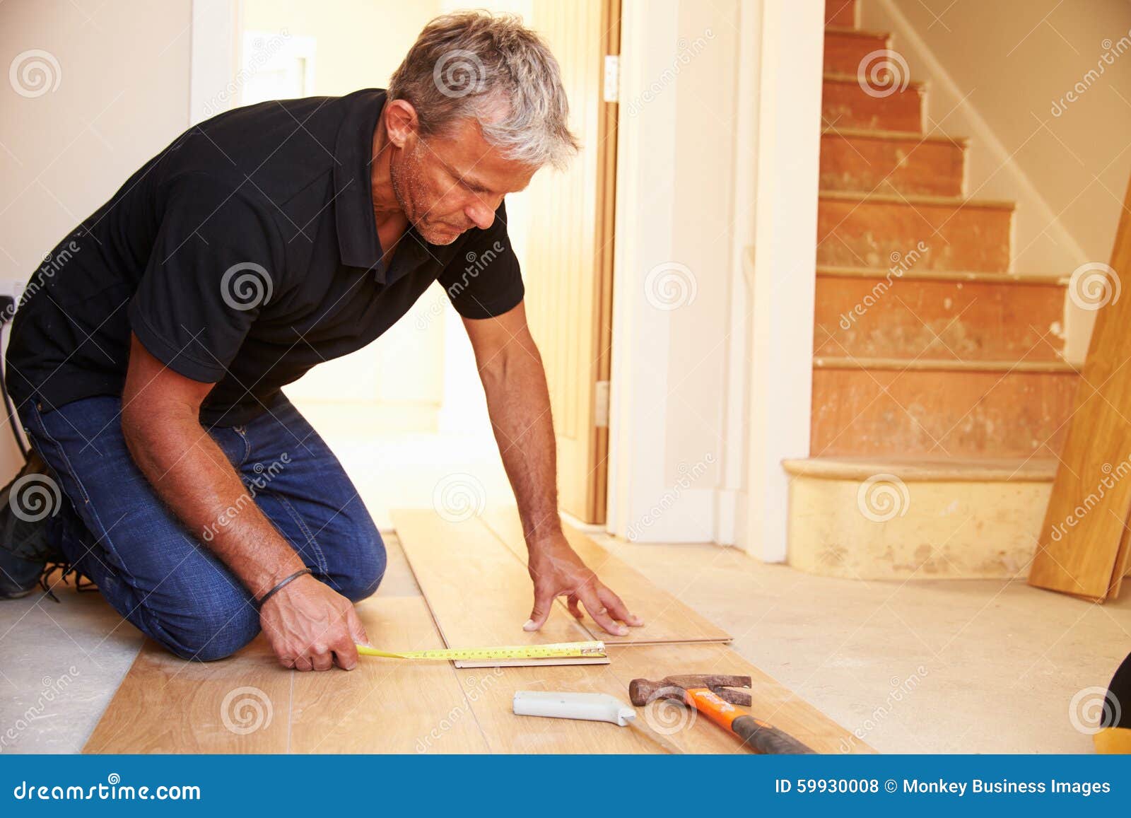 Man Laying Wood Panel Flooring during a House Refurbishment Stock Photo ...