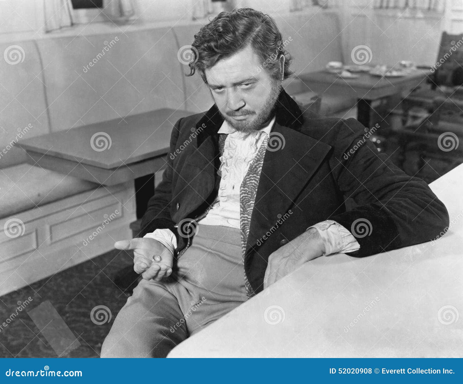 Man Leaning Against a Counter in a Restaurant with a Ring in His Hand ...