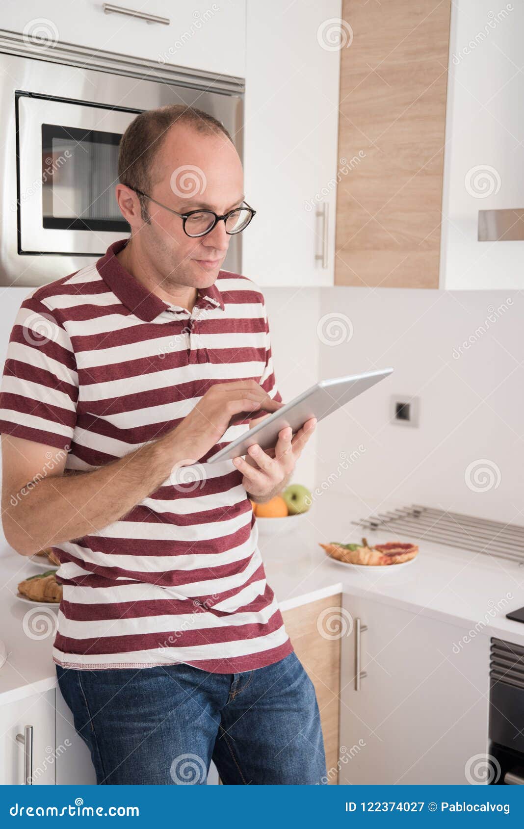 Man Texting on a Pc Table in a Kitchen Stock Image - Image of ...